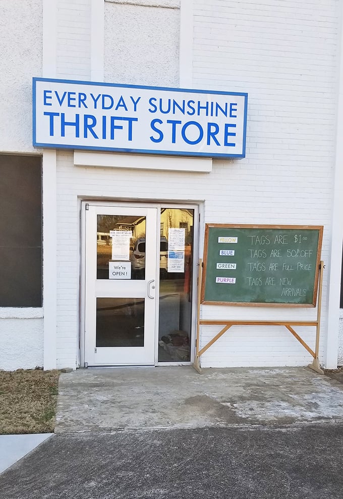 The chalkboard tells the story: blue tags half-off, yellow tags full price. Thrifting here requires both luck and tactical timing.