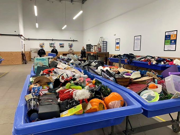 Blue bins of possibility at Goodwill's As-Is Outlet. Where the thrill of the hunt meets prices so low they seem like mathematical errors.