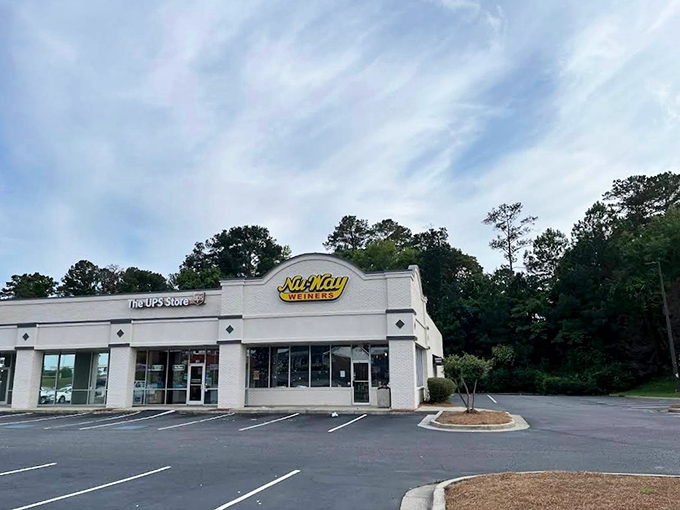 Nu-Way's bright white building houses hot dog history. Inside this unassuming storefront, a century-old tradition of distinctive dogs continues to thrive.