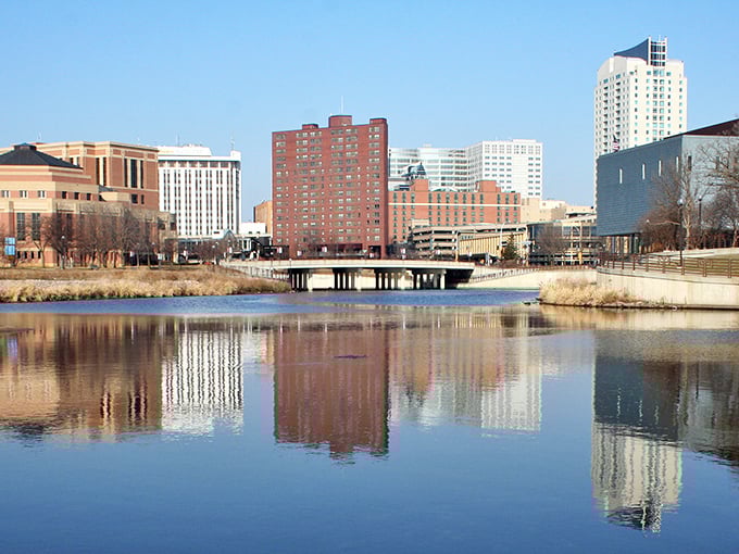 The Zumbro River reflects Rochester's growing cityscape. Water and architecture in perfect harmony&mdash;no wonder people love living here!