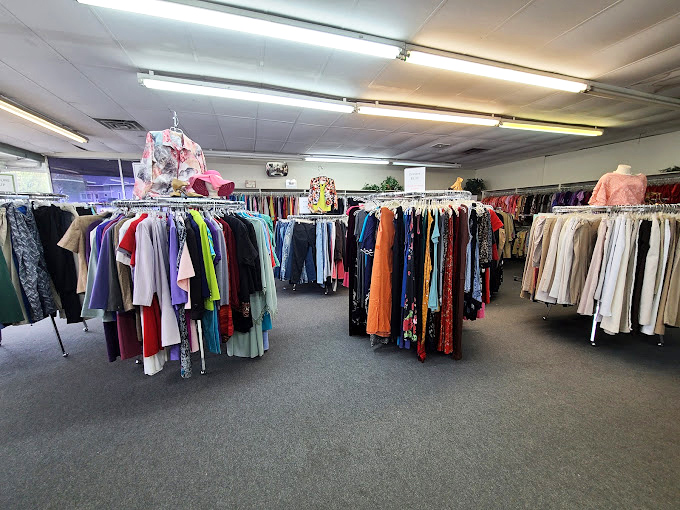 Racks of carefully organized clothing await new owners in this no-frills space where every purchase fights hunger locally.