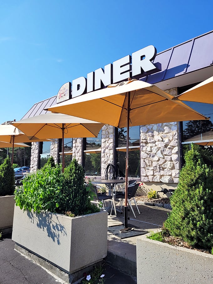 Yellow umbrellas stand ready for alfresco dining at the Shoreline, where Connecticut mornings taste even better with fresh air.