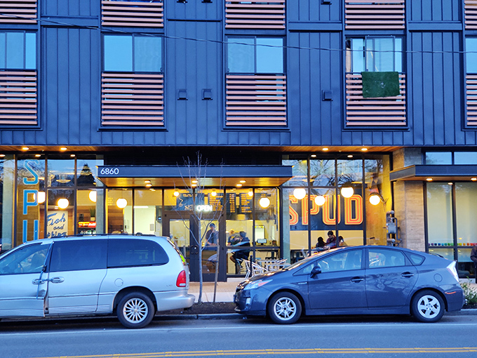 The neon "SPUD" sign glows like a beacon for the fried fish faithful. Simple name, extraordinary results.