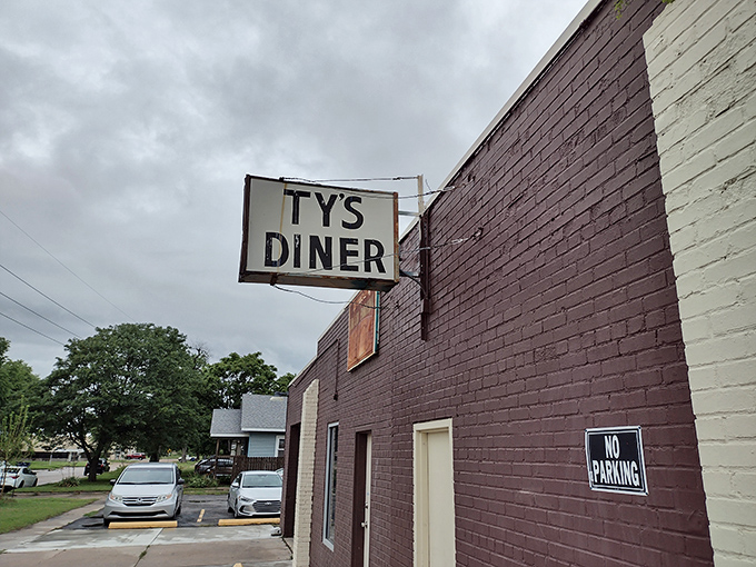 That simple brick exterior and vintage sign hint at the old-school burger craftsmanship waiting inside Ty's Diner.