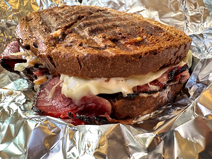 Pastrami so tender it practically surrenders at first bite, nestled between rye that somehow maintains its structural integrity. 