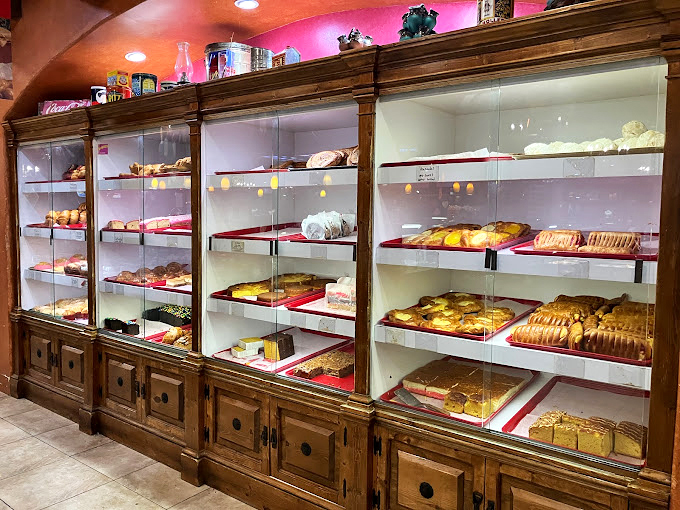 The display case at Mama Ines&mdash;where willpower goes to die. Each shelf offers a different way to rationalize dessert before noon.