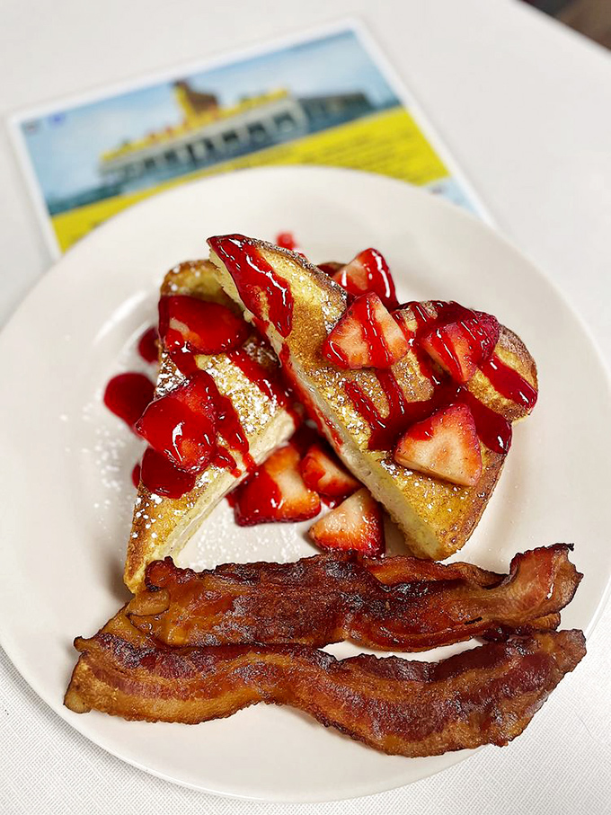 French toast that puts ordinary breakfast to shame. Those strawberries aren't just garnish&mdash;they're little jewels of morning perfection.