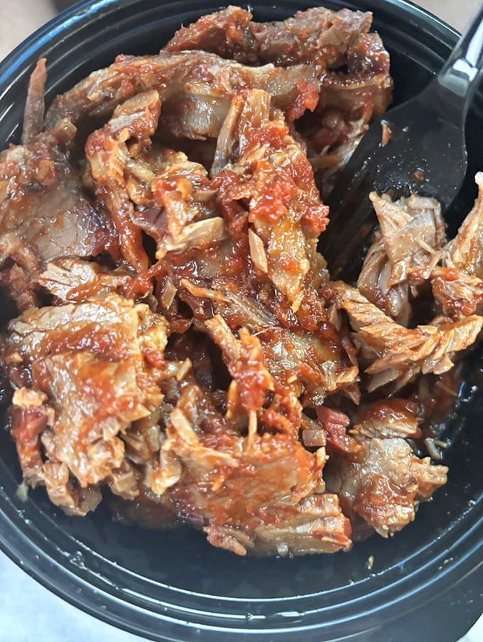 Brisket with that telltale smoke ring that makes barbecue aficionados weak in the knees. The foil cradles it like the treasure it truly is.