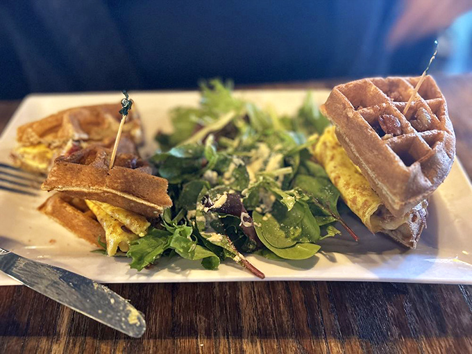 The BLT reimagined: crispy waffles standing in for bread, with spring greens providing the perfect fresh counterpoint to savory fillings.