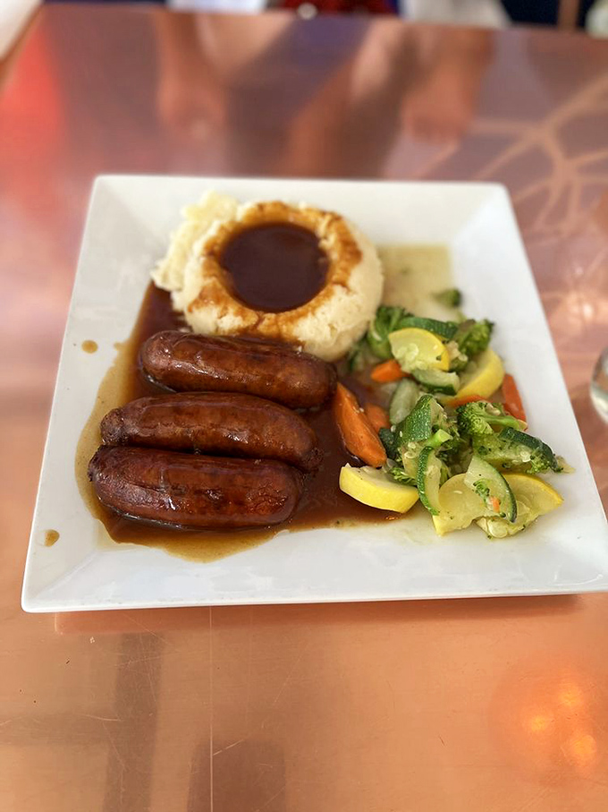 Bangers and mash: where plump sausages nestle against a volcano of mashed potatoes with a crater of gravy. Pure comfort on a plate.