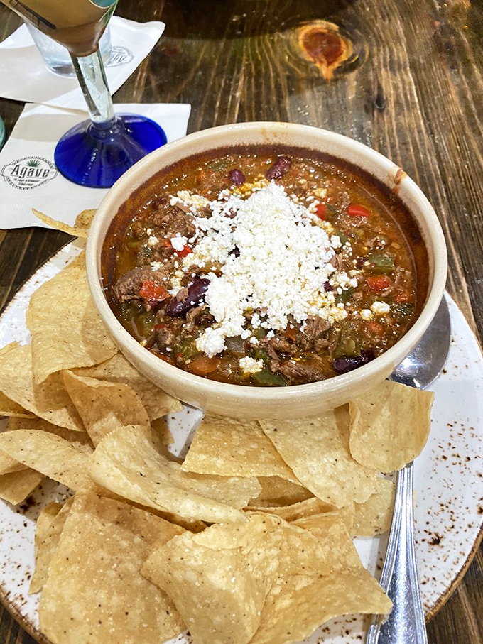 A bowl of Mexican chili that's worth the trip alone, topped with queso fresco and served with chips that are clearly overachievers.