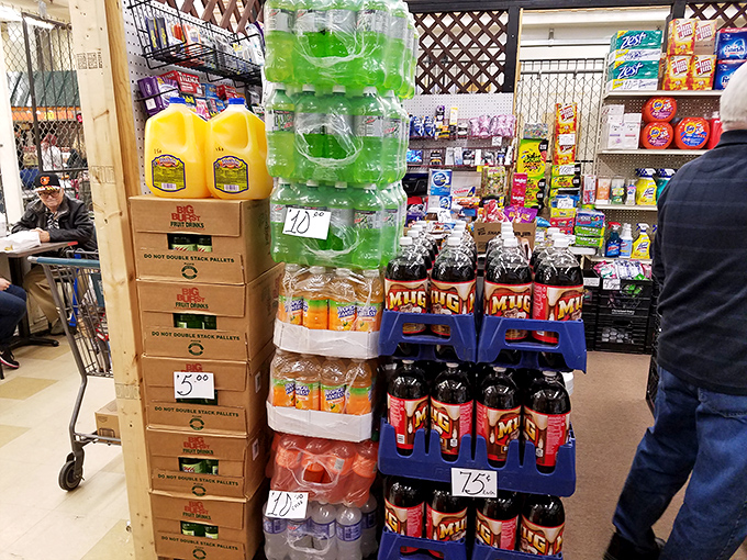 Hydration station! Stacked cases of colorful beverages stand like liquid soldiers, ready to quench the thirst of dedicated bargain hunters at rock-bottom prices.