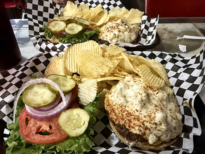 This isn't just a burger—it's a masterpiece of melted cheese that's spread to the edges of the plate, creating a golden halo around seasoned beef.