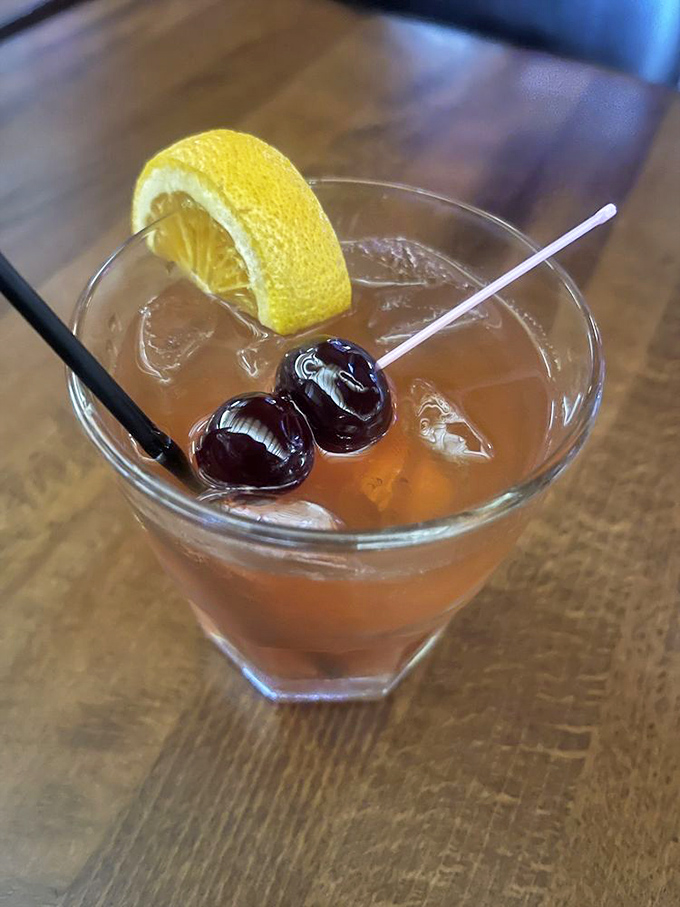 Not just a cocktail, but a proper introduction to your evening. Those cherries aren't garnish&mdash;they're the welcoming committee to flavor town.