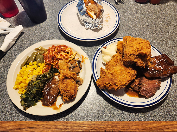 Two plates that tell the story of buffet strategy&mdash;a little of everything, with tactical emphasis on the fried chicken battalion.