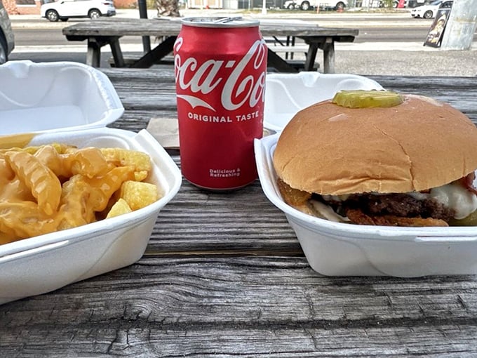 Cheese fries and a classic burger alongside a Coca-Cola - the holy trinity of American comfort food, served picnic-style.