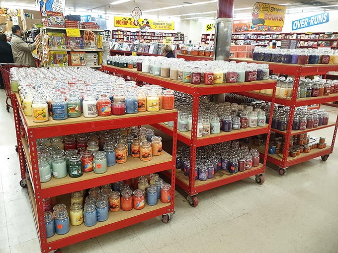 A rainbow of scented candles stands at attention on red metal shelves. Enough fragrance options to make your home smell like a bakery, garden, or beach retreat.