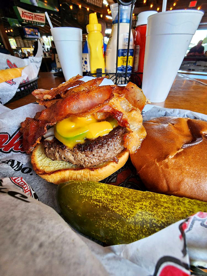 This burger doesn't just have cheese and bacon&mdash;it's wearing them like medals of honor. The pickle stands guard.