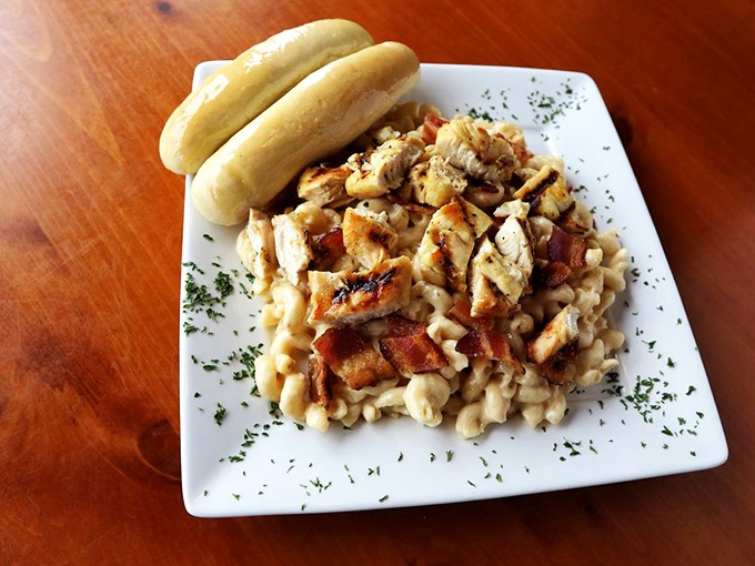 Comfort food gets a gourmet upgrade. Tender chicken over creamy mac & cheese with fresh breadsticks standing by for the inevitable sauce-sopping.
