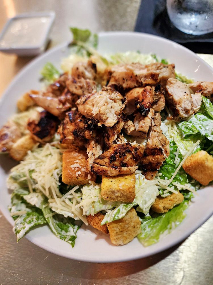 Salad skeptics, prepare to be converted. Perfectly grilled chicken atop crisp romaine with all the classic Caesar trimmings&mdash;a meal that satisfies without apology.