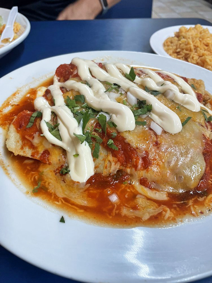 Enchiladas swimming in vibrant sauce, blanketed with melted cheese and that signature drizzle of crema &ndash; comfort food that speaks a universal language.