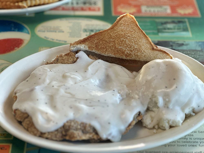Chicken fried steak smothered in gravy so good you'll want to write it love letters. The toast is just there to soak up your tears of joy.