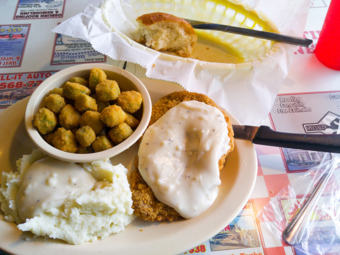 Southern comfort on a plate&mdash;chicken fried steak smothered in pepper gravy alongside creamy mashed potatoes and fried okra that tastes like a warm Arkansas hug. 
