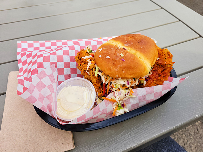 This isn't just a sandwich; it's an architectural masterpiece of crispy chicken, fresh veggies, and pillowy bun that requires both hands and napkins. 
