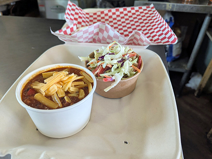 Chili topped with cheese and a side of fresh slaw &ndash; because sometimes you need a break from the heat without leaving the flavor party. 