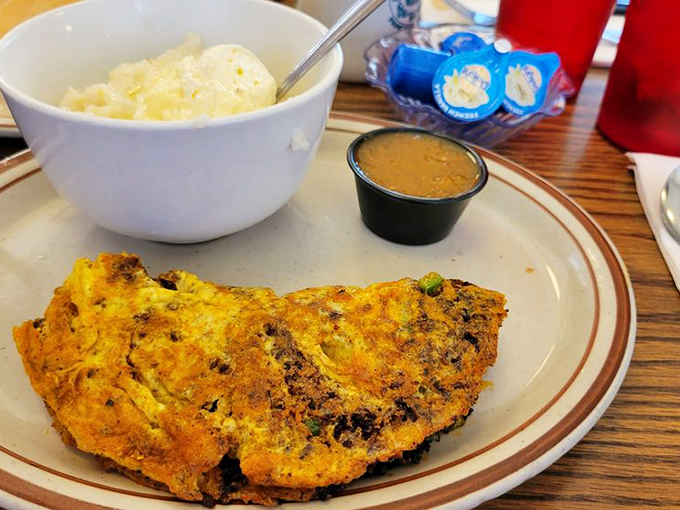 This isn't just an omelet&mdash;it's a treasure chest of flavors with each forkful revealing savory surprises and golden potato companions.