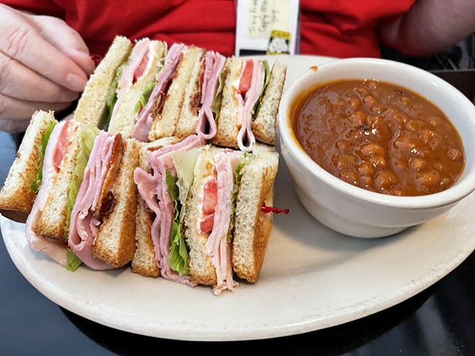 This club sandwich with baked beans isn't just lunch&mdash;it's three perfect stories of ham, turkey and bacon that deserves its own Kansas zip code.