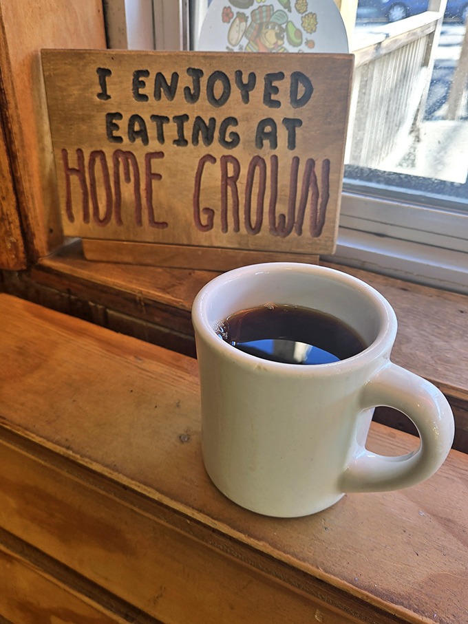 A simple coffee moment that speaks volumes. The wooden sign says what your taste buds will confirm&mdash;this place understands what matters in life.