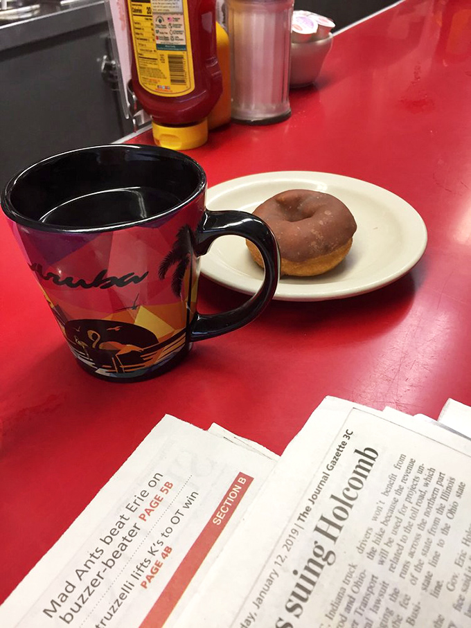 Morning meditation: steaming coffee alongside a chocolate-glazed donut. Some spiritual practices involve silence and fasting&mdash;I prefer this approach.