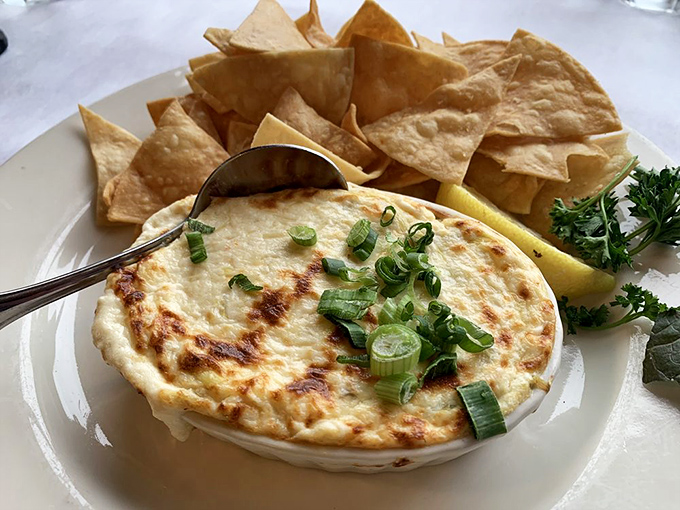 Bubbling hot crab dip with tortilla chips standing by for duty&mdash;like tiny shovels eager to help you mine for liquid gold.