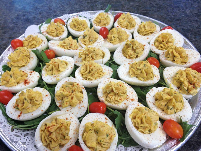 Deviled eggs arranged like edible jewelry. These aren't just appetizers&mdash;they're little oval ambassadors of happiness with paprika halos.