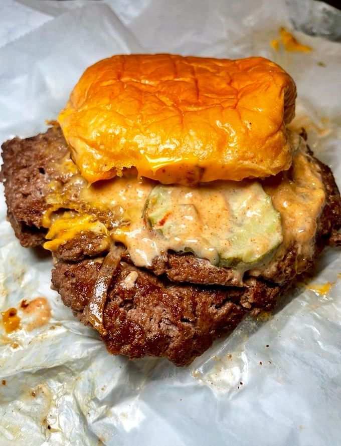 This isn't just a burger; it's an architectural marvel of beef, cheese, and sauce that demands both respect and napkins.