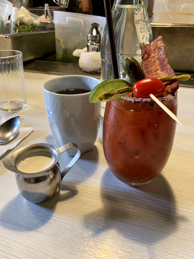 The Bloody Mary stands at attention like a morning soldier, armed with bacon, pickle, and enough spice to wake up even the most stubborn taste buds.