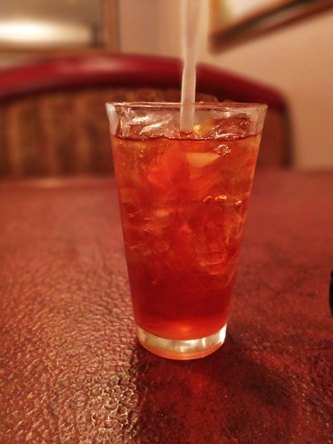 That ruby-red Italian soda isn't just a drink; it's the opening act that sets the stage for the culinary concert to follow.