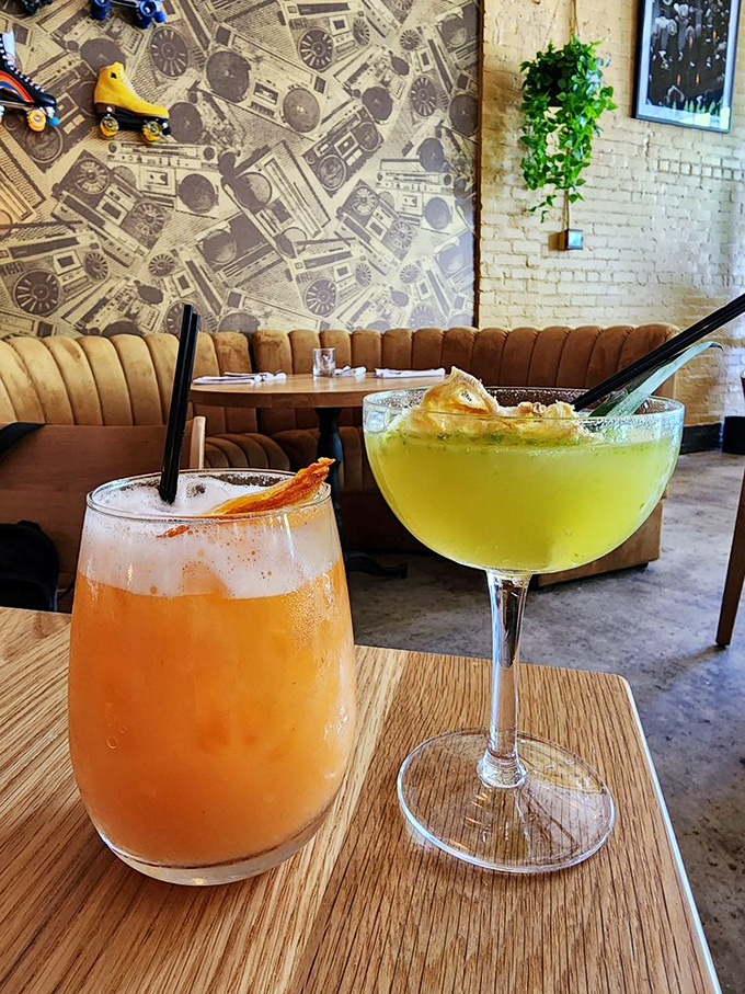 Cocktails at Marcus aren't just drinks—they're liquid personality tests. Choose the vibrant orange or the cool green, both promising a delightful detour from sobriety.