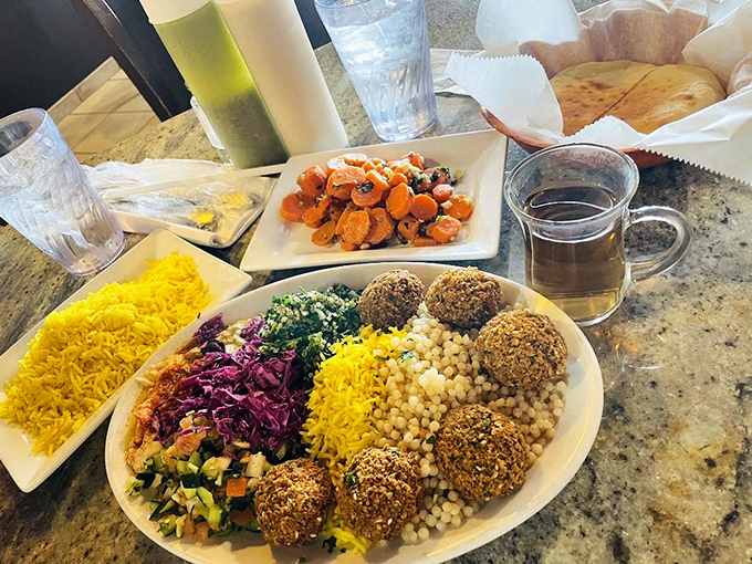 A festival of textures and colors on a plate. Those falafel balls have the perfect crisp-to-fluff ratio that veggie lovers dream about.