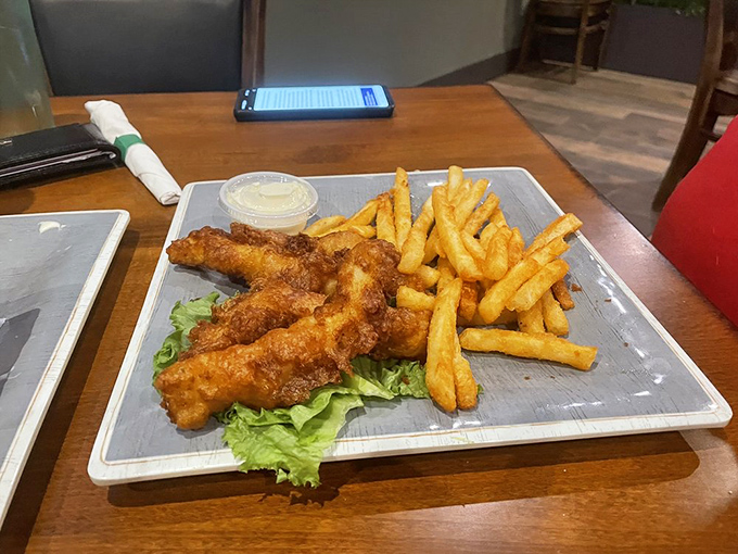 Fish and chips that would make a Londoner homesick. Golden-battered perfection that shatters with each bite, revealing steamy white fish beneath.