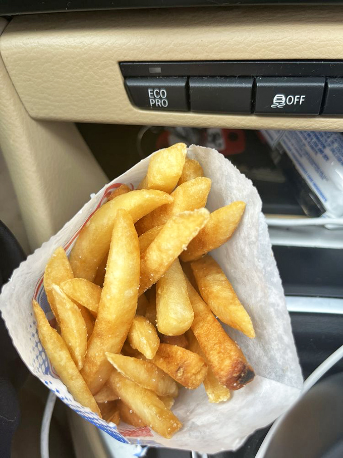 Golden, crispy potato perfection nestled in your car's cupholder. These aren't just fries—they're the supporting actors that steal the show.