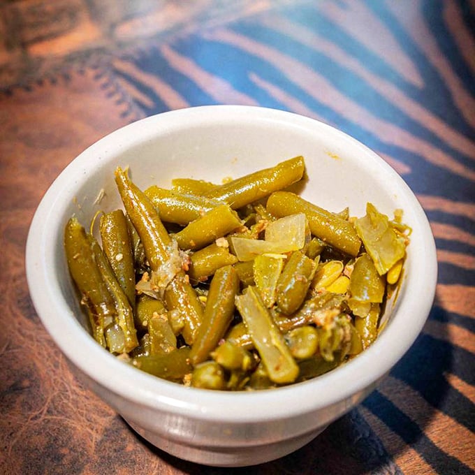 These aren't your cafeteria lady's green beans. They've been slow-cooked with love until they surrender all their vegetal dignity.
