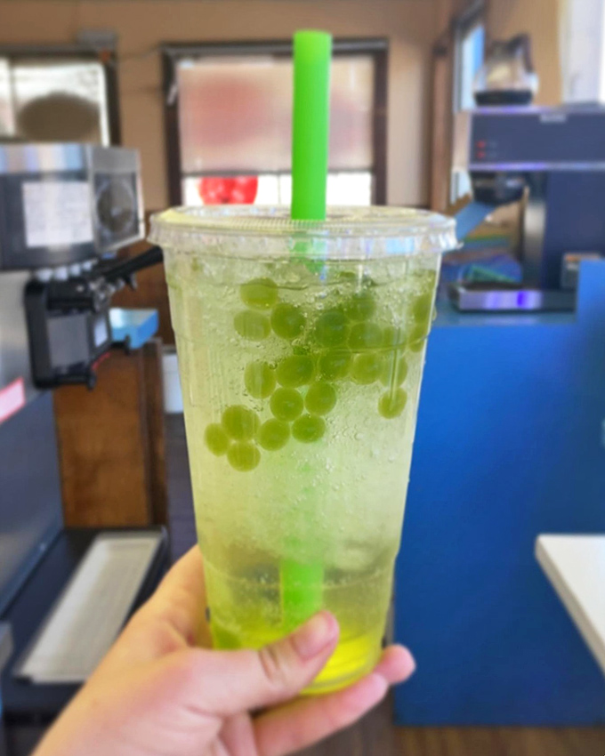 Not your average soda! This green apple drink with bursting boba pearls is like a science experiment you can sip.