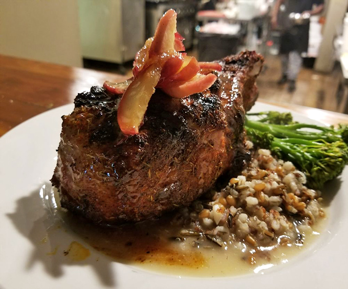 This pork chop isn't just dinner; it's a masterclass in the art of the grill, complete with a supporting cast of perfectly prepared sides.