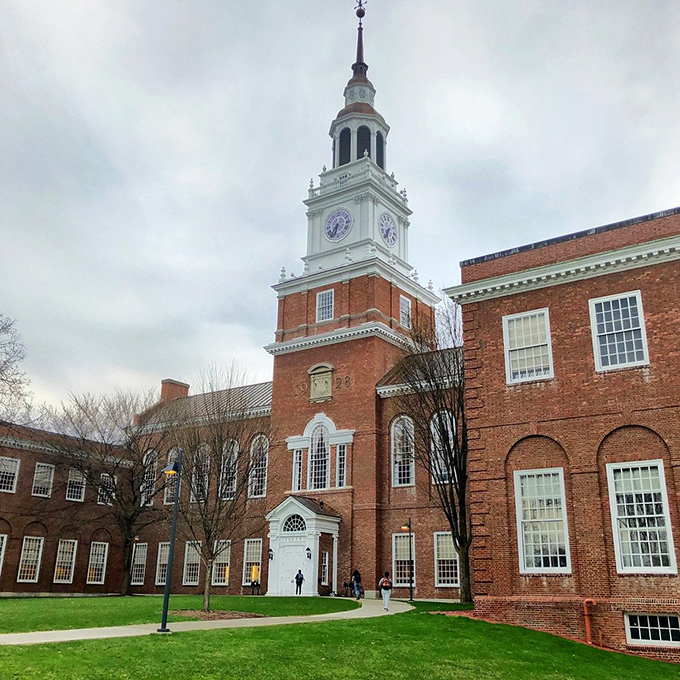 Baker Tower stands tall against moody skies, Dartmouth's iconic landmark since 1928. This architectural grande dame has photobombed countless graduation pictures through the decades.