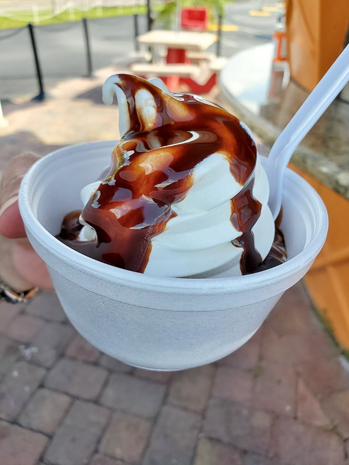Hot fudge and vanilla soft serve &ndash; a temperature tango in a cup. The hot-cold contrast creates a sensory experience that never gets old.