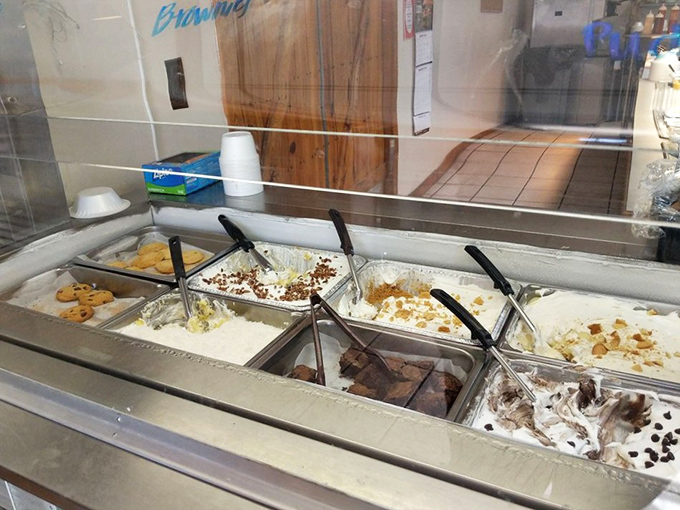 The dessert station—where diet plans go to die happy deaths. Ice cream and toppings patiently wait for your resistance to crumble like their neighboring cookies.