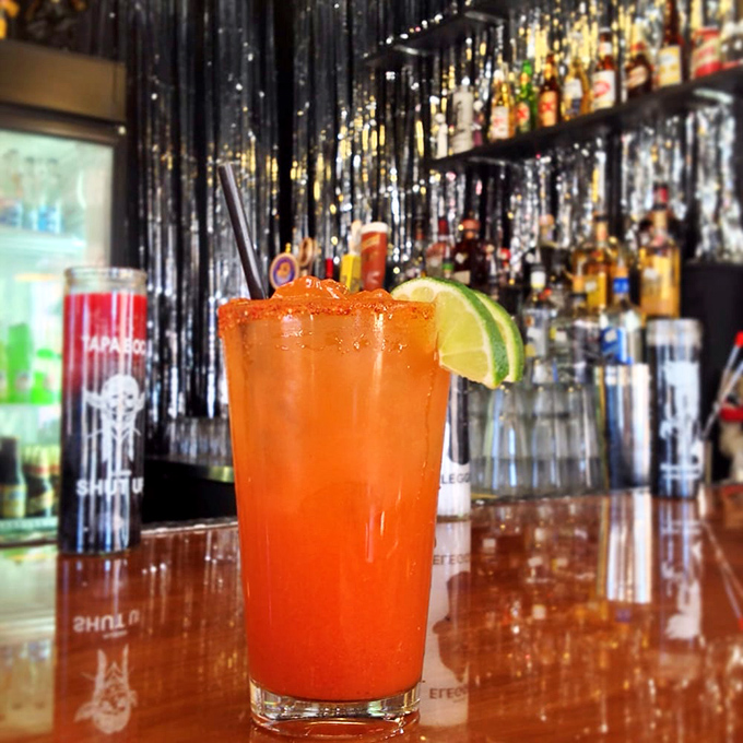 That sunset-colored drink isn't just refreshing&mdash;it's practically medicinal. A michelada that makes every sip feel like a mini vacation.