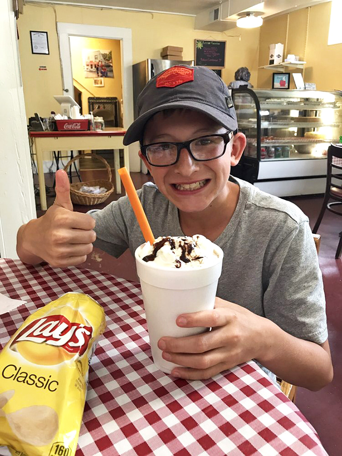 Even the milkshakes come with a side of joy, as evidenced by this young customer's enthusiastic thumbs-up. Happiness in a cup.